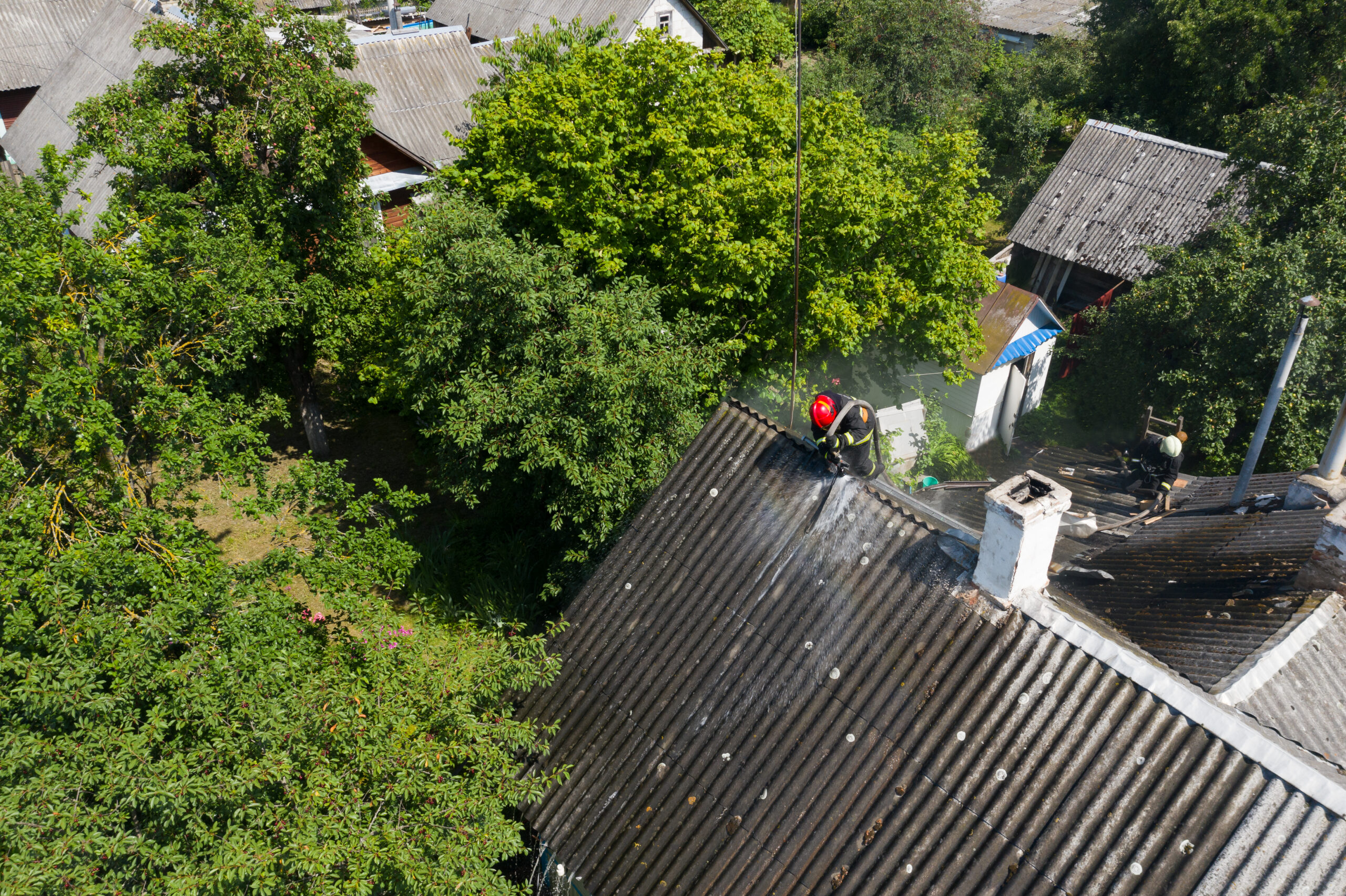 firefighter on the roof extinguishes the fire view from above.